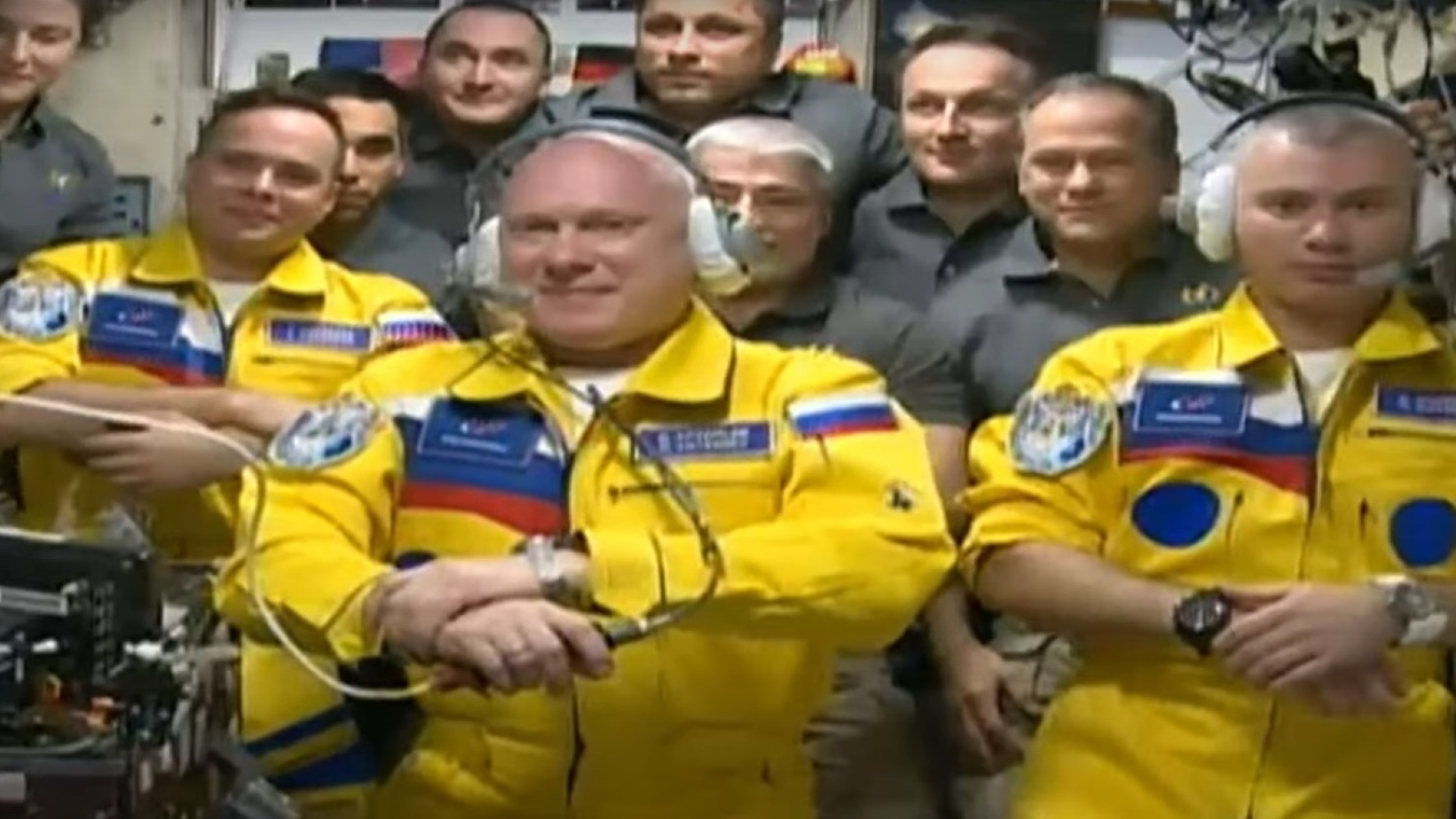 Russian cosmonauts board ISS wearing yellow and blue, the colors of the ...