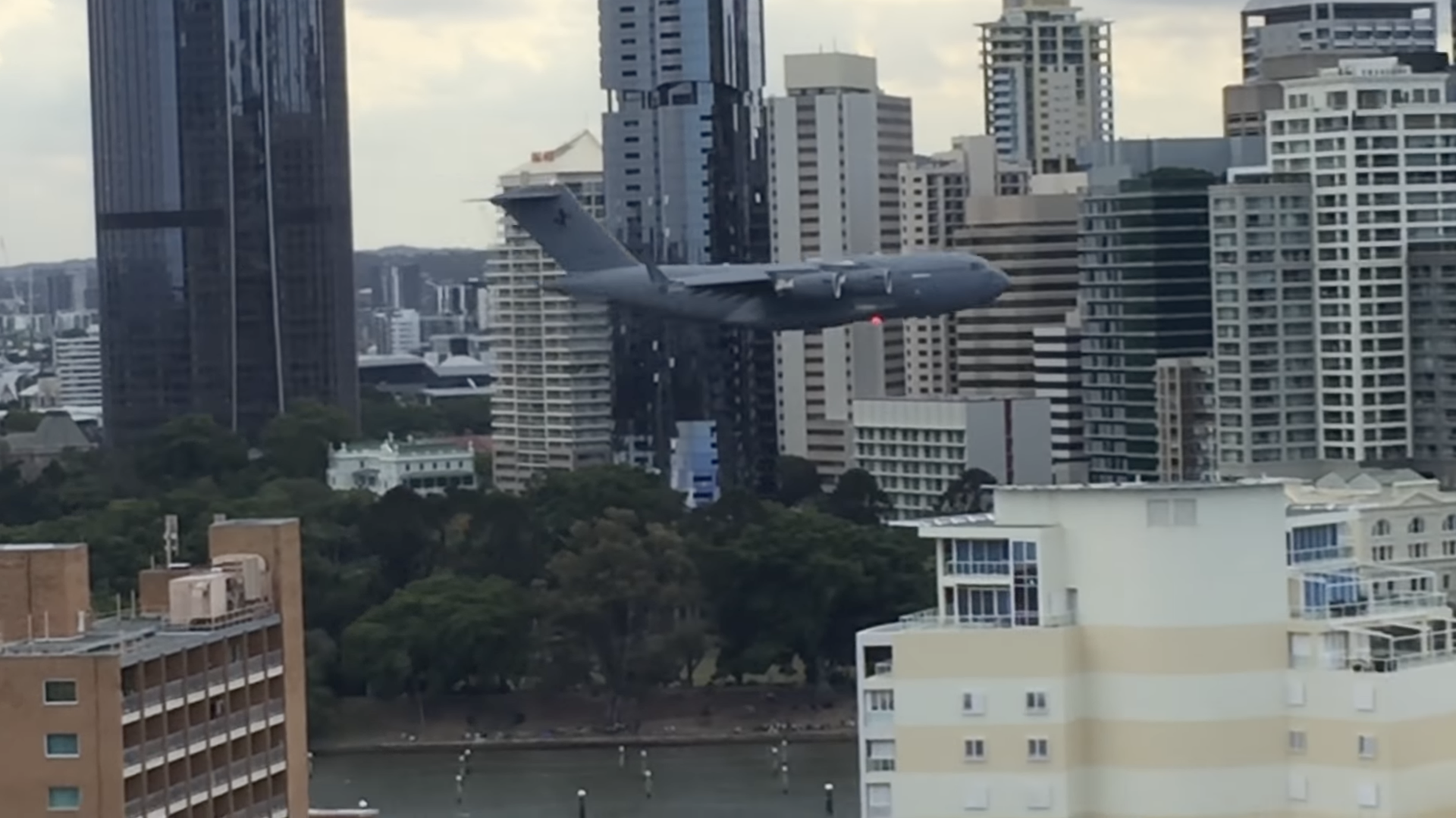 Watch a Massive Military Jet Fly Between Buildings in Australia