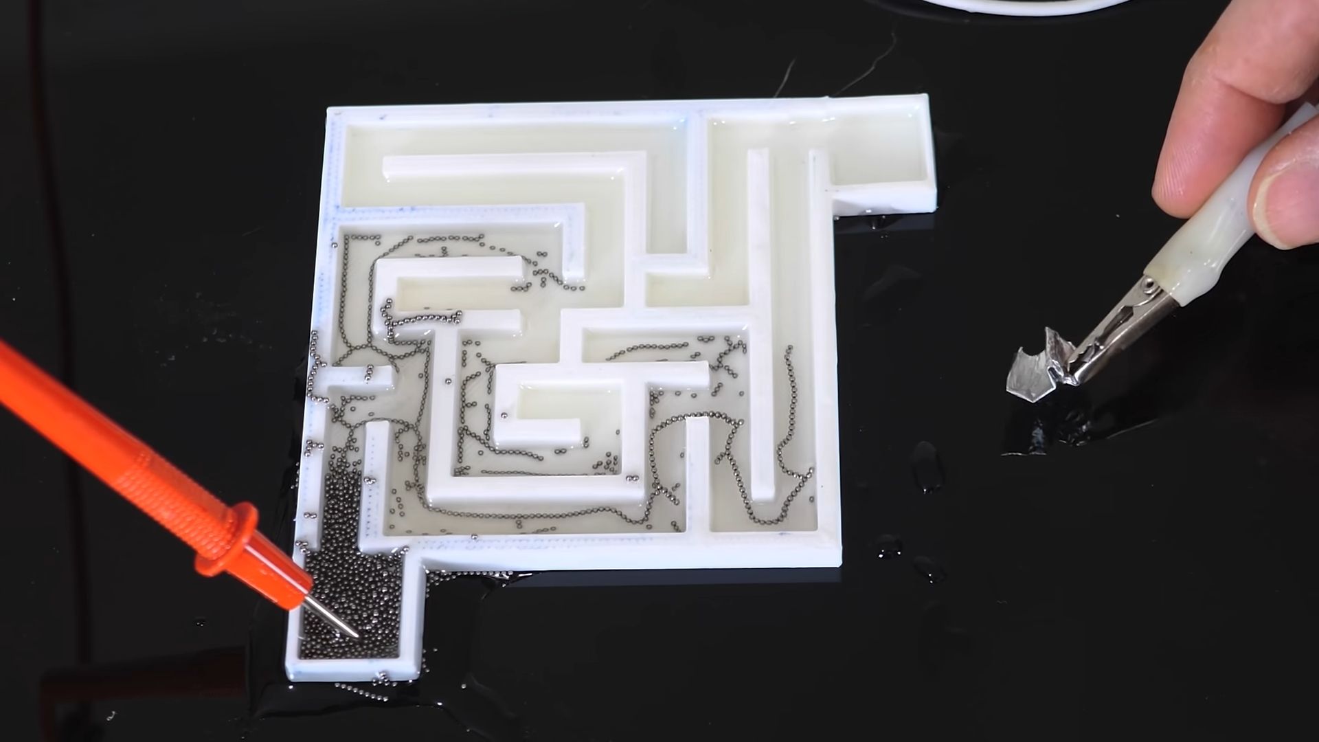 Making Self-Assembling Wires That Find Their Way Through a Maze