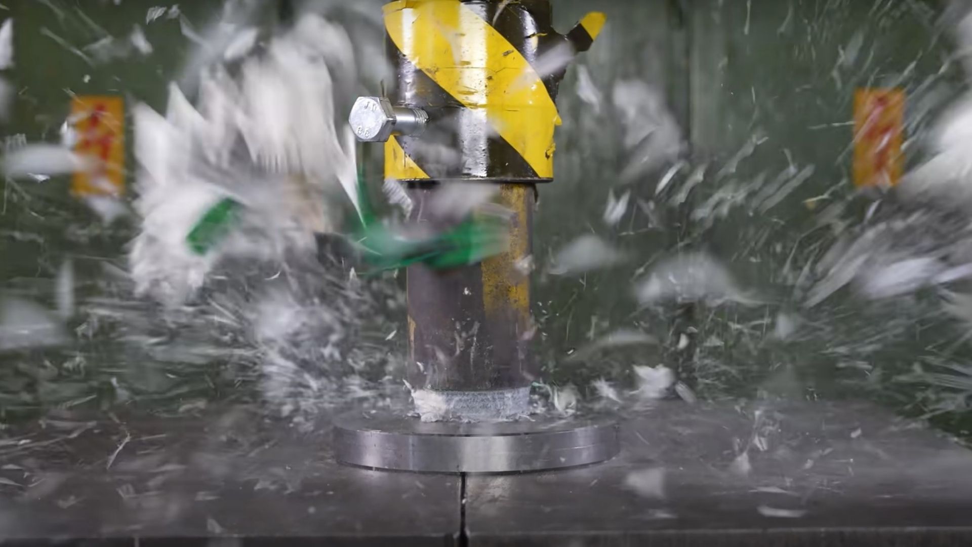 Watch a 150-ton hydraulic press break down while crushing a stack of books